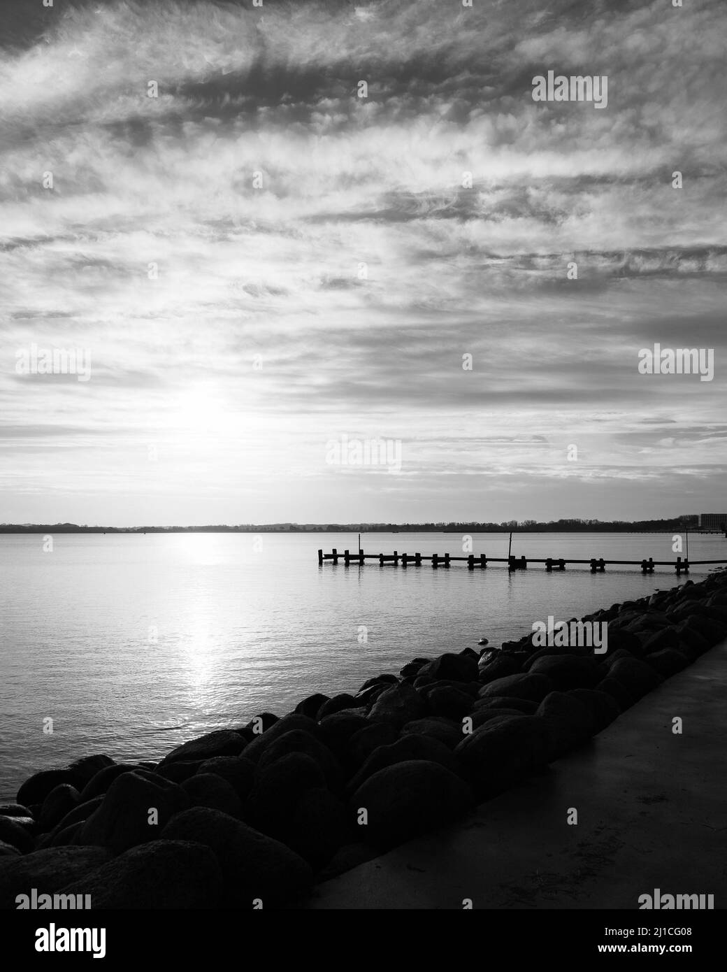 A grayscale of a boardwalk on the ocean Stock Photo - Alamy