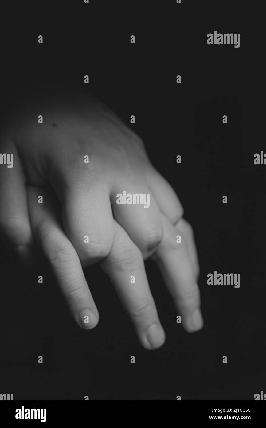 A vertical shot of the dramatic view of the hands in grayscale Stock ...