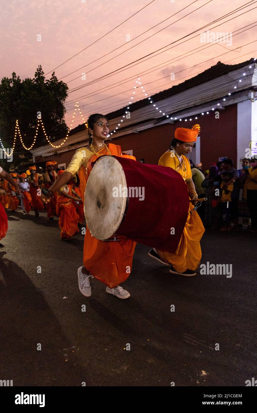 Women dressed in traditional attire, playing heavy drums called dhol ...