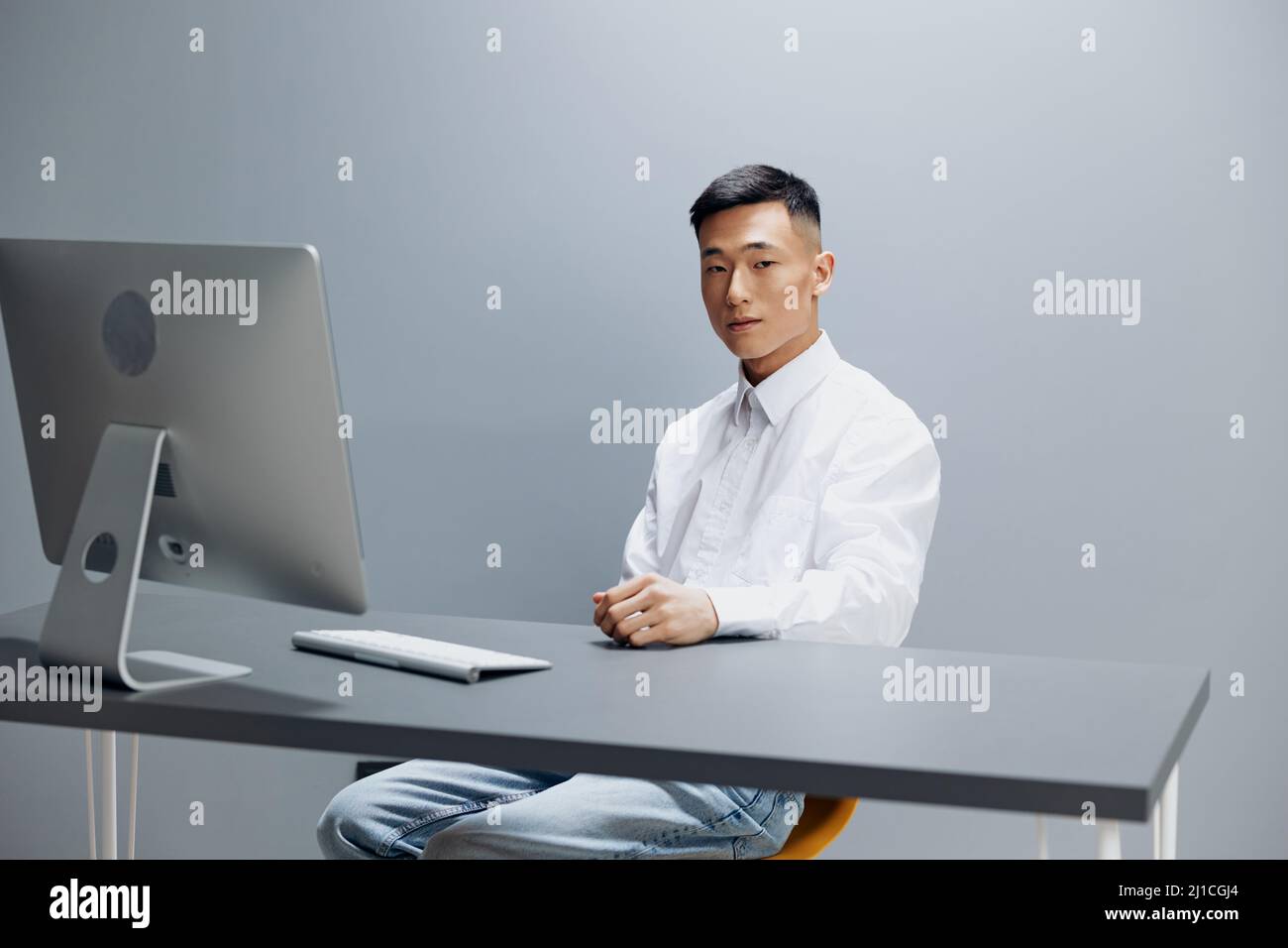 worker sit at a desk in front of a computer isolated background Stock ...