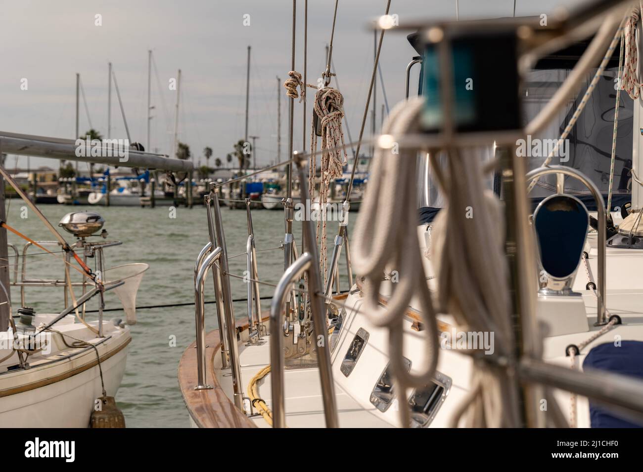 Ropes and other rigging of a sail boat docked in a marina. Selective ...