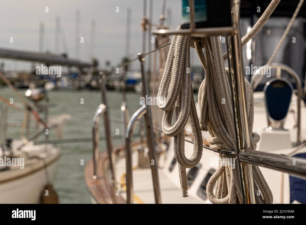 Ropes and other rigging of a sail boat docked in a marina. Selective ...