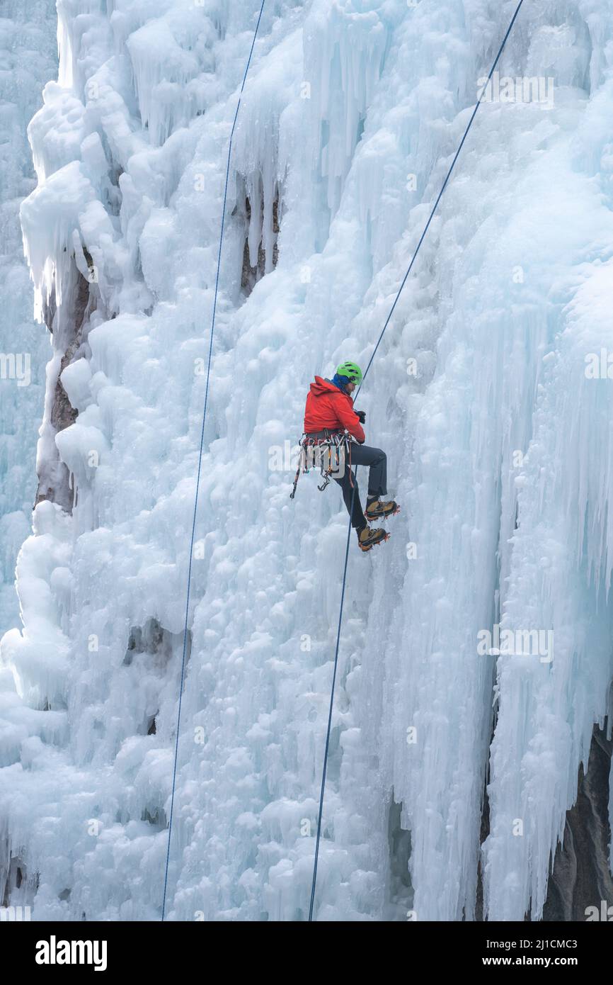 An ice climber rappels down a 160' high ice wall in the Pick o' the Vic ...