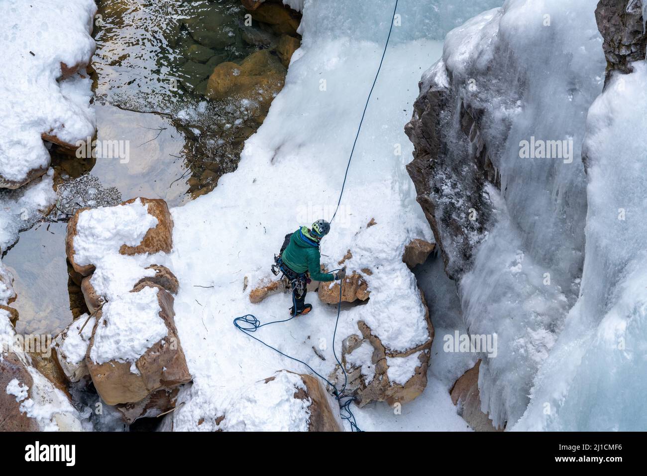 An ice climber prepares for a 160' climb from the bottom of the ...