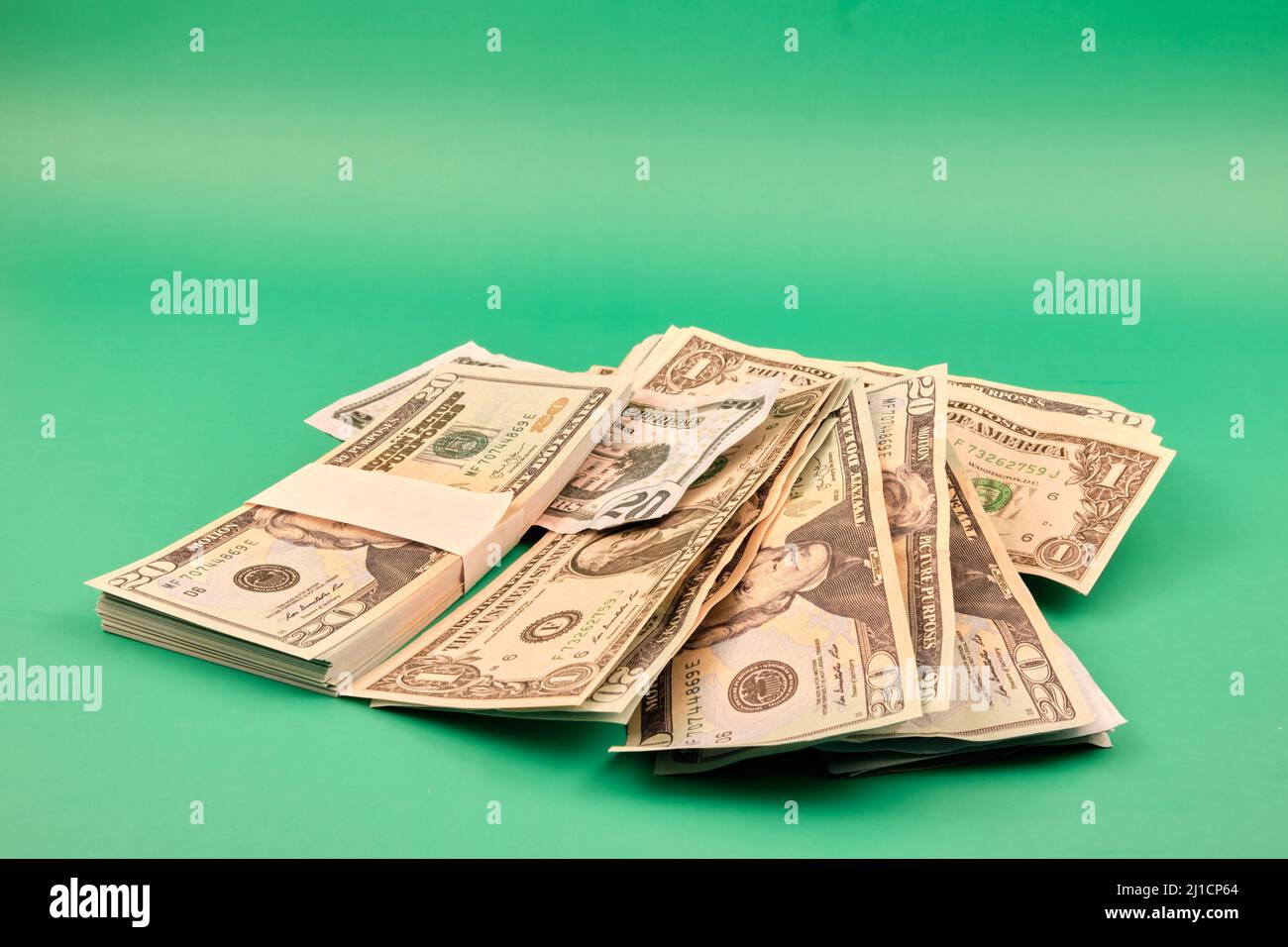 A pile of dollars on a green table. Photograph in horizontal format ...