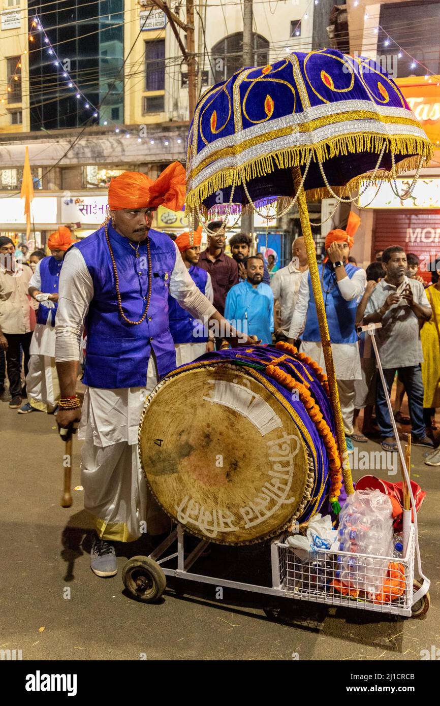 Man playing massive drum called dhol kept on trolley for the Shigmo ...