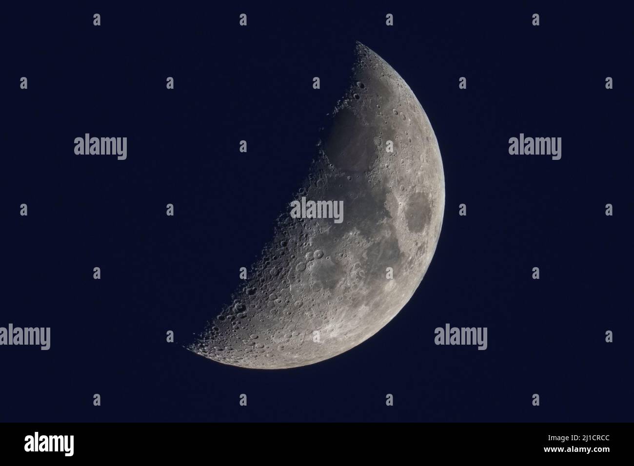 A closeup of a half of the moon against the black background Stock ...