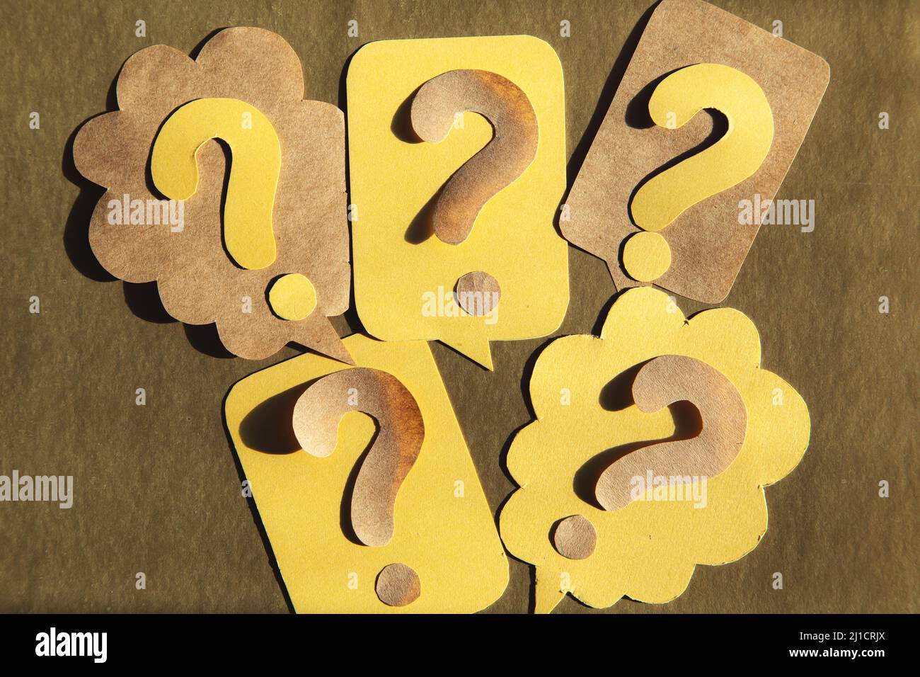 Question mark on speech bubbles, golden background. View from above ...
