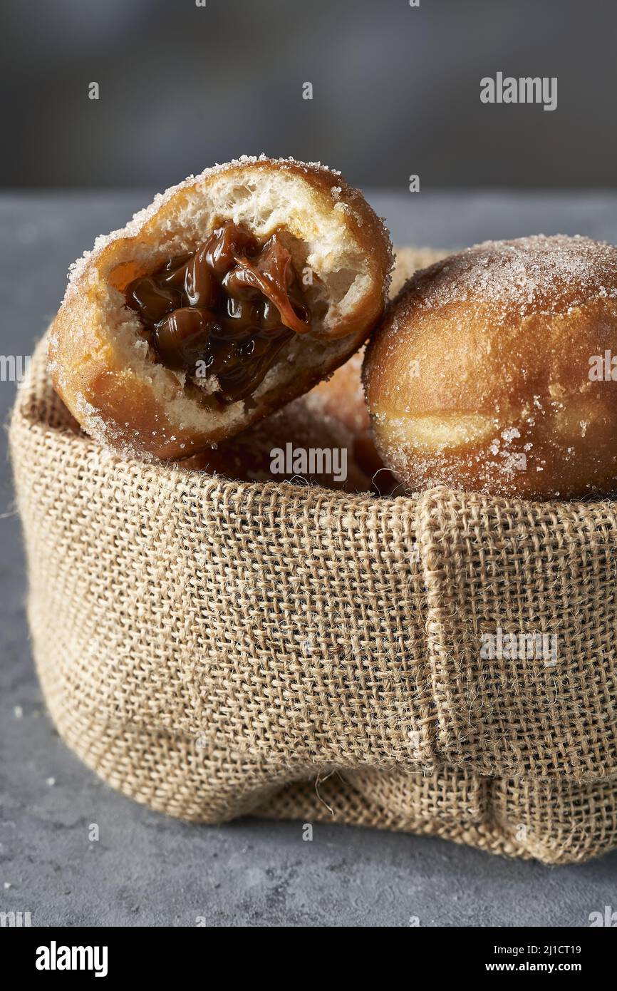 Close-up of Berliner stuffed with dulce de leche. The berliners are ...