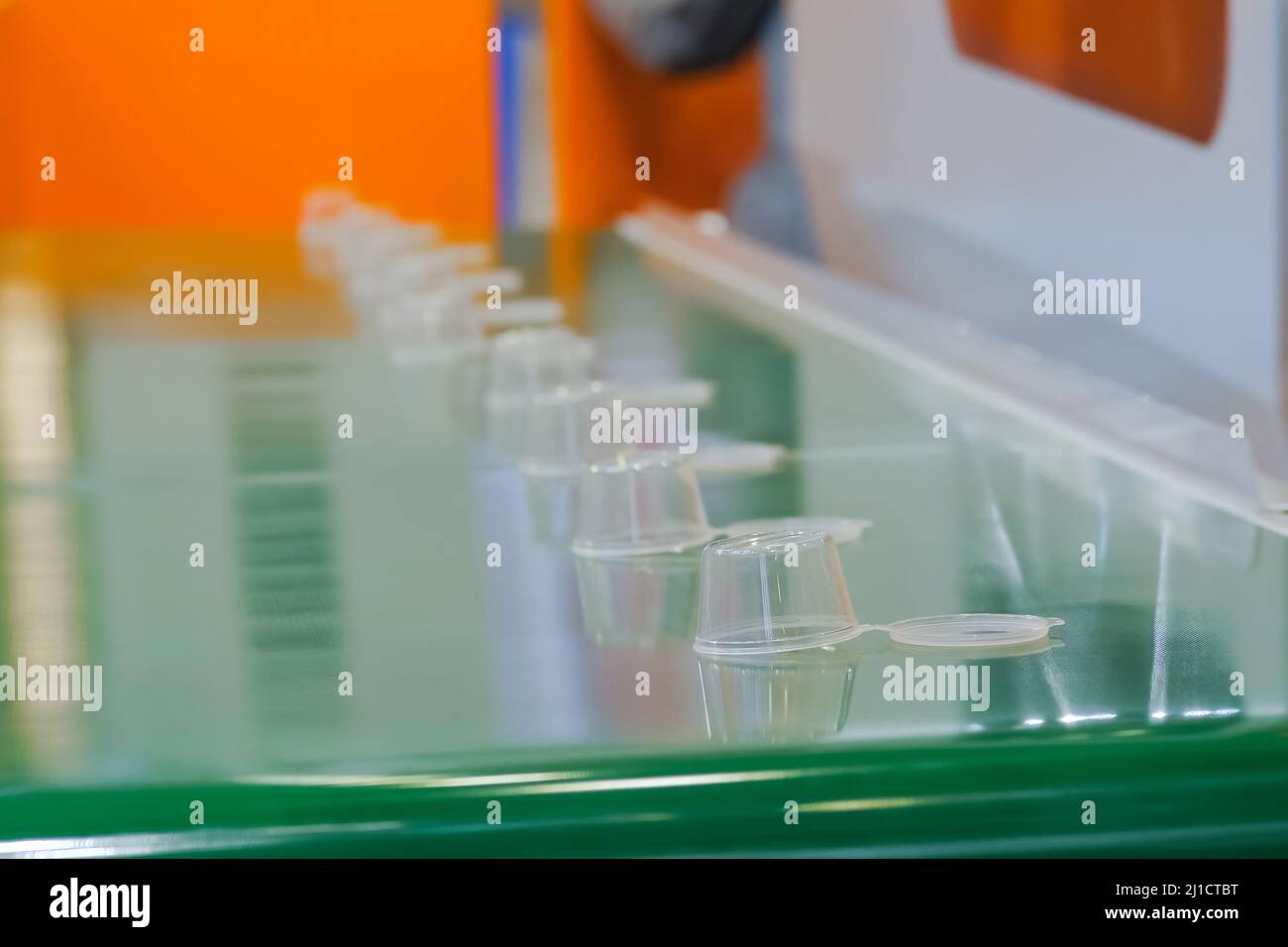 Empty plastic cups moving on conveyor belt at exhibition Stock Photo ...