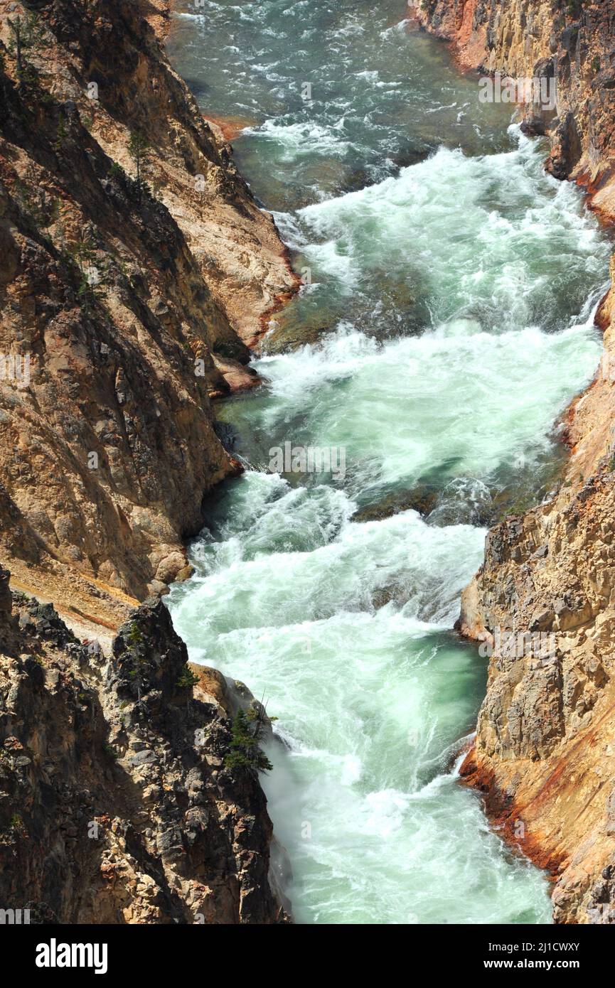 As the Yellowstone River leaves Lower Falls, its curving waterway is ...