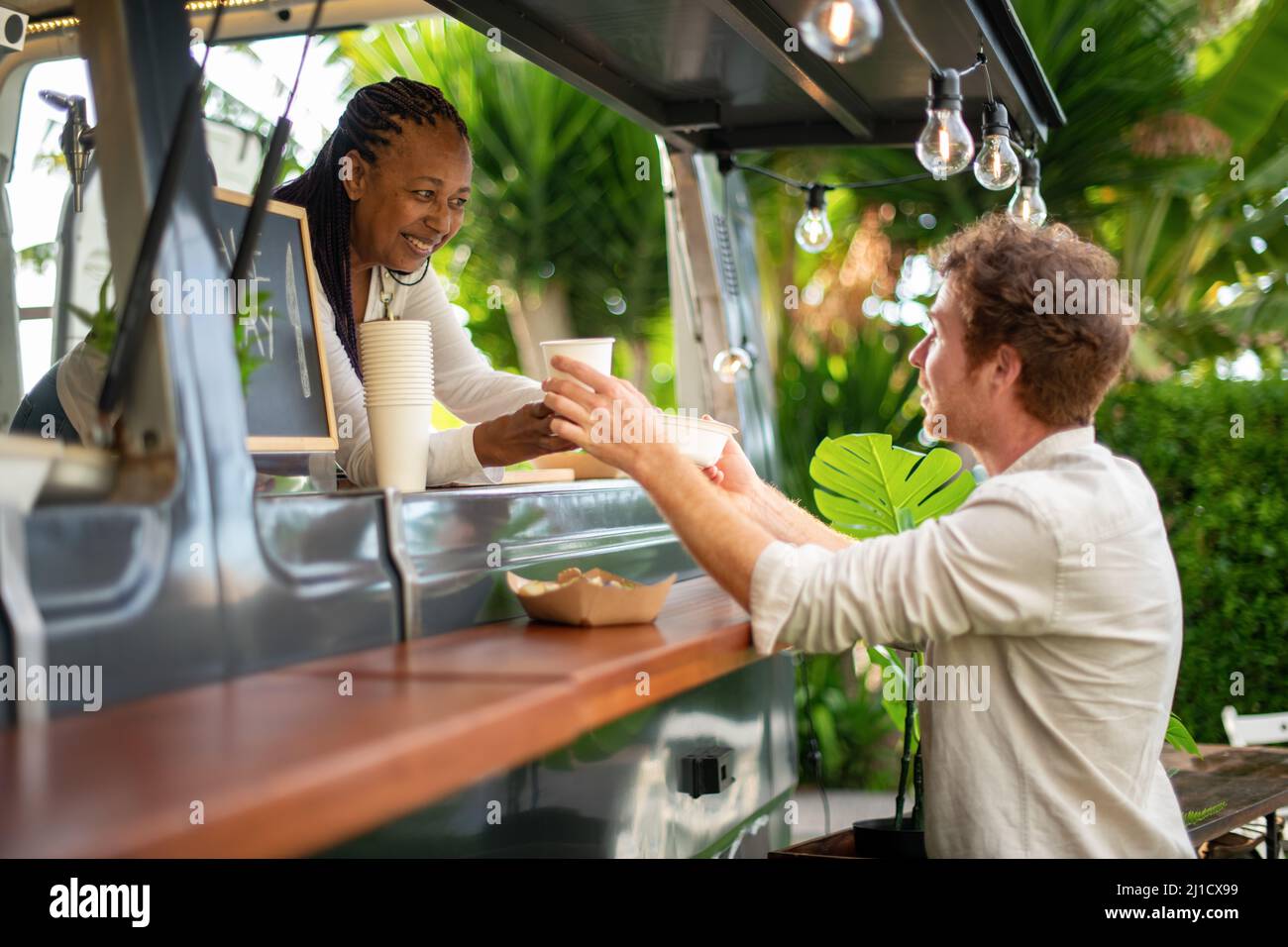 Man buying drink in food truck Stock Photo - Alamy