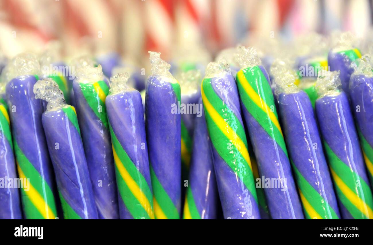 Background image shows a group of purple, yellow and green, striped ...