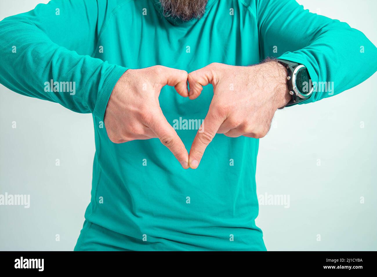 Young man making heart shape with hands Stock Photo - Alamy
