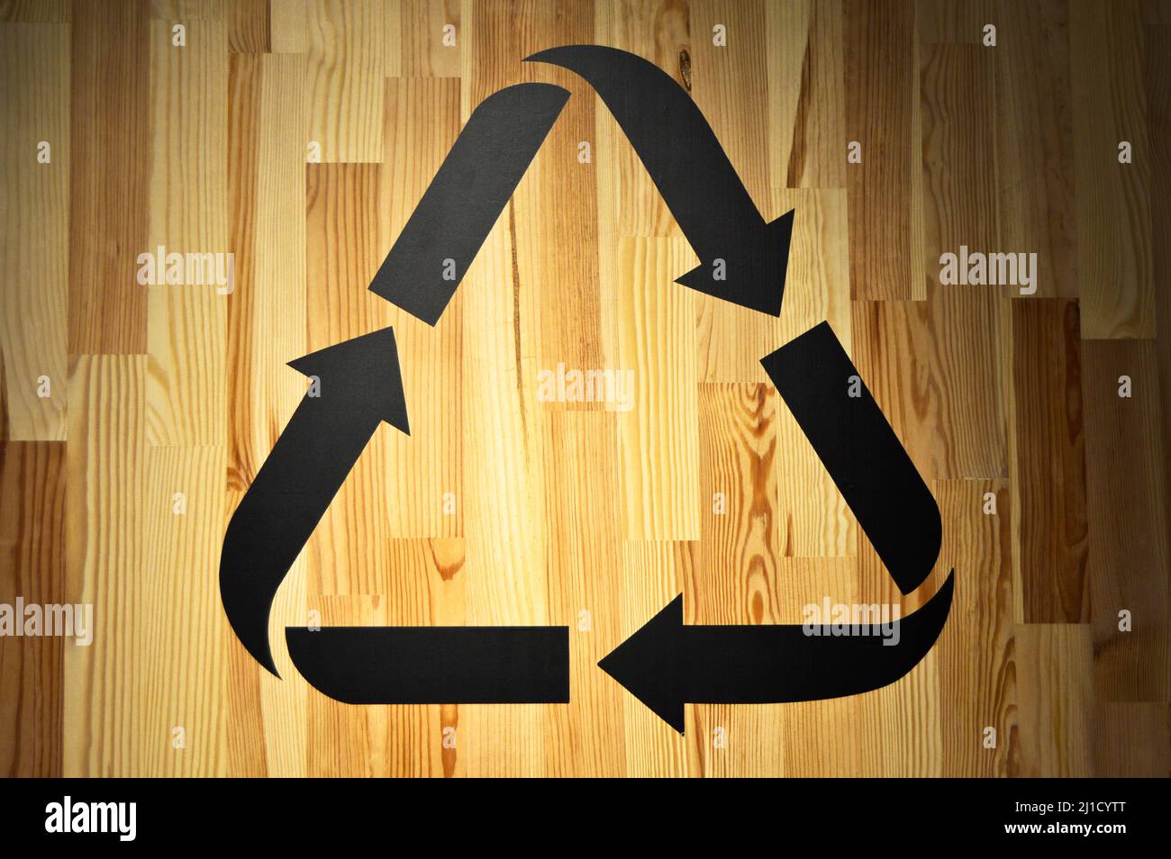 Recycling symbol on brown and beige grunge pine wooden background ...