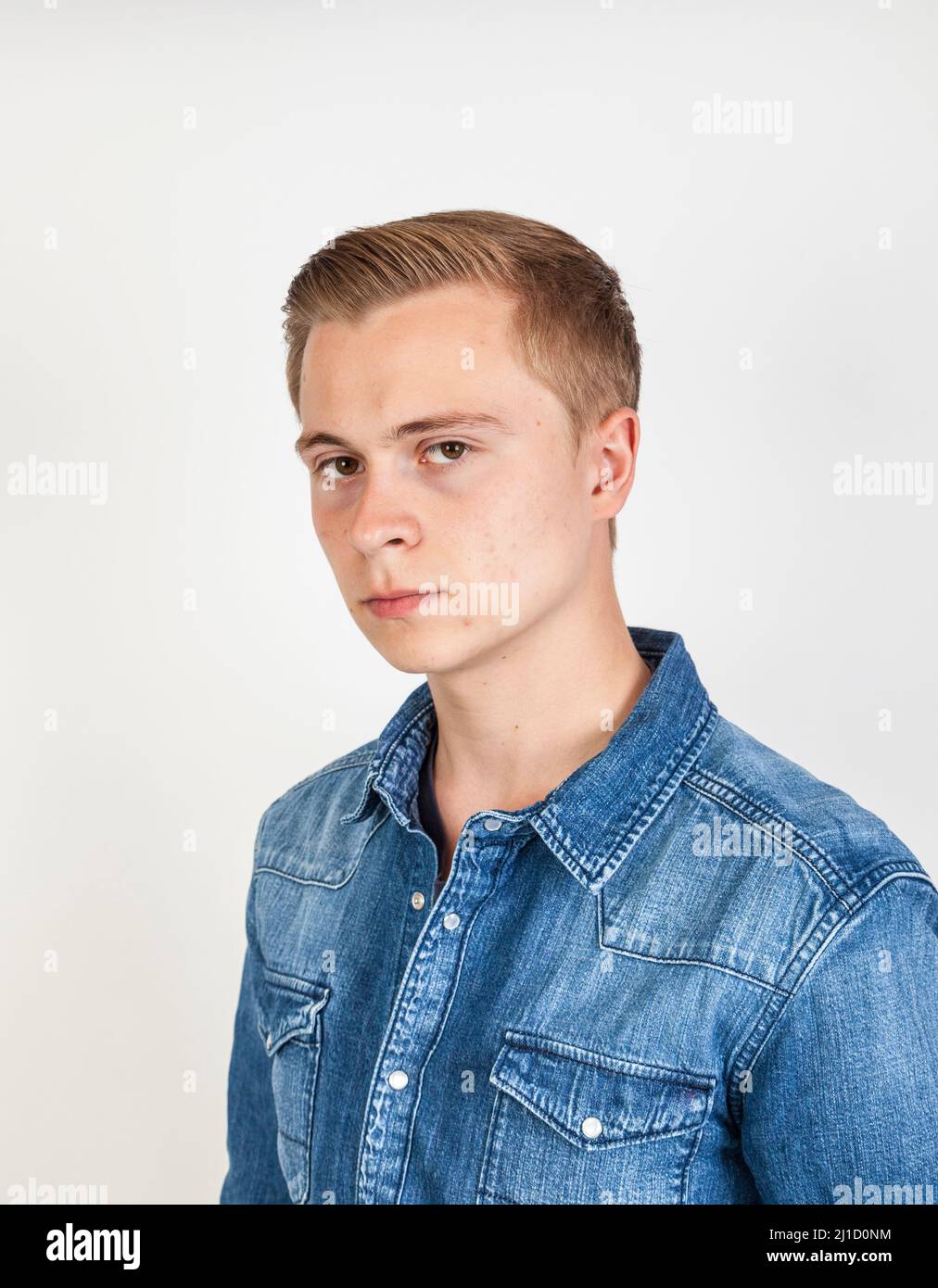 portrait of angry looking boy posing in studio Stock Photo - Alamy