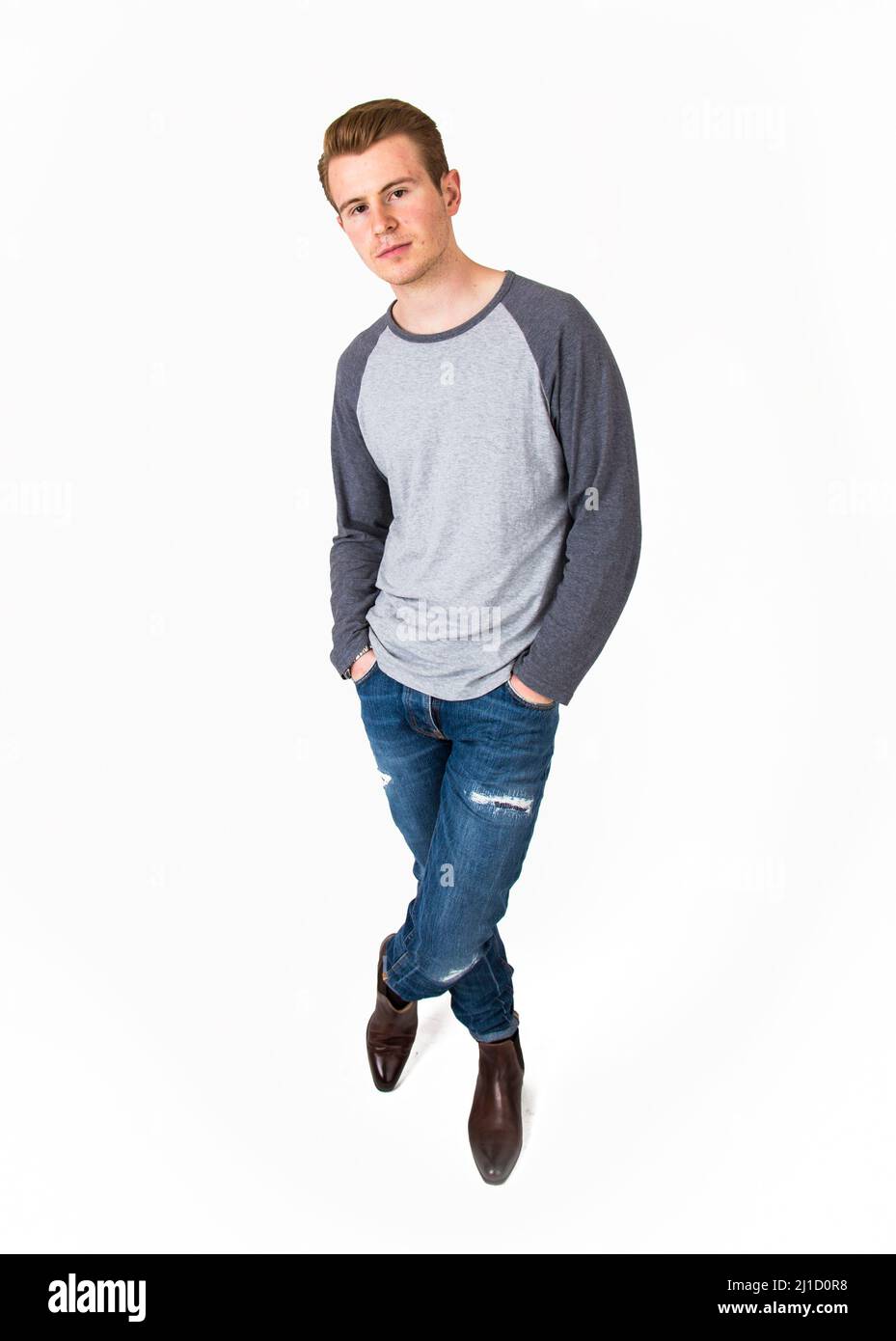 cool boy with cool facial expression poses in studio isolated on white ...