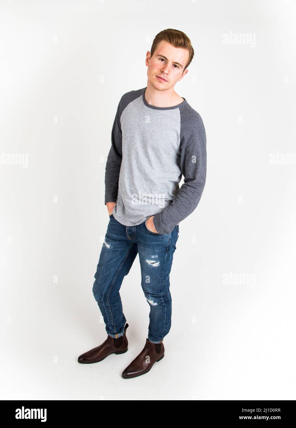 cool boy with cool facial expression poses in studio isolated on white ...