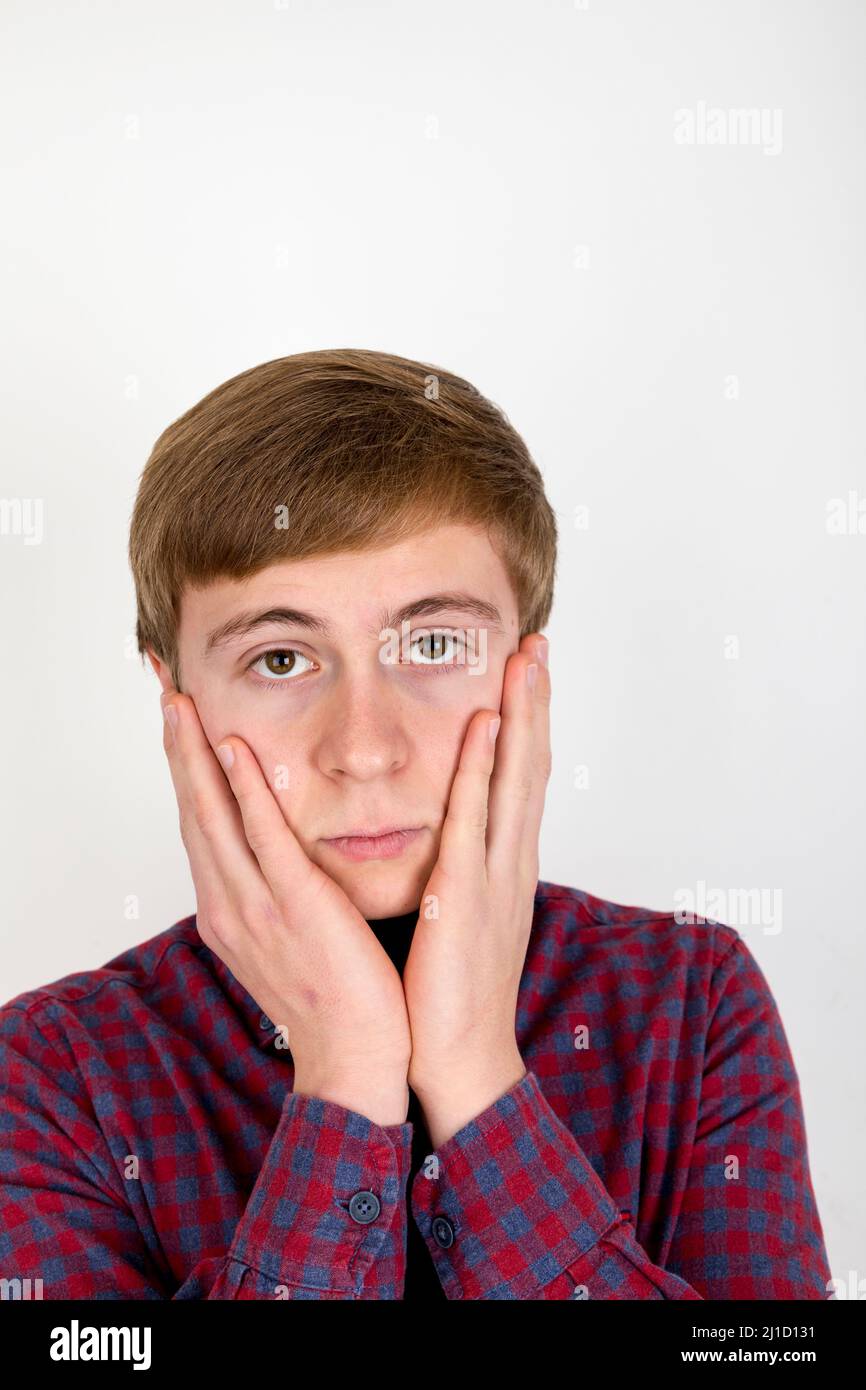 Portrait of sad handsome young man on white background, cheerful ...