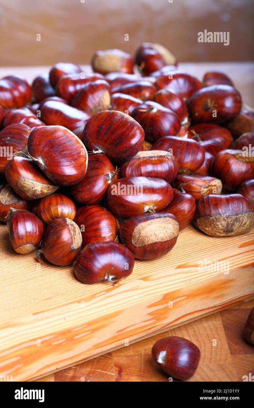 Chestnusts on wooden background Stock Photo - Alamy
