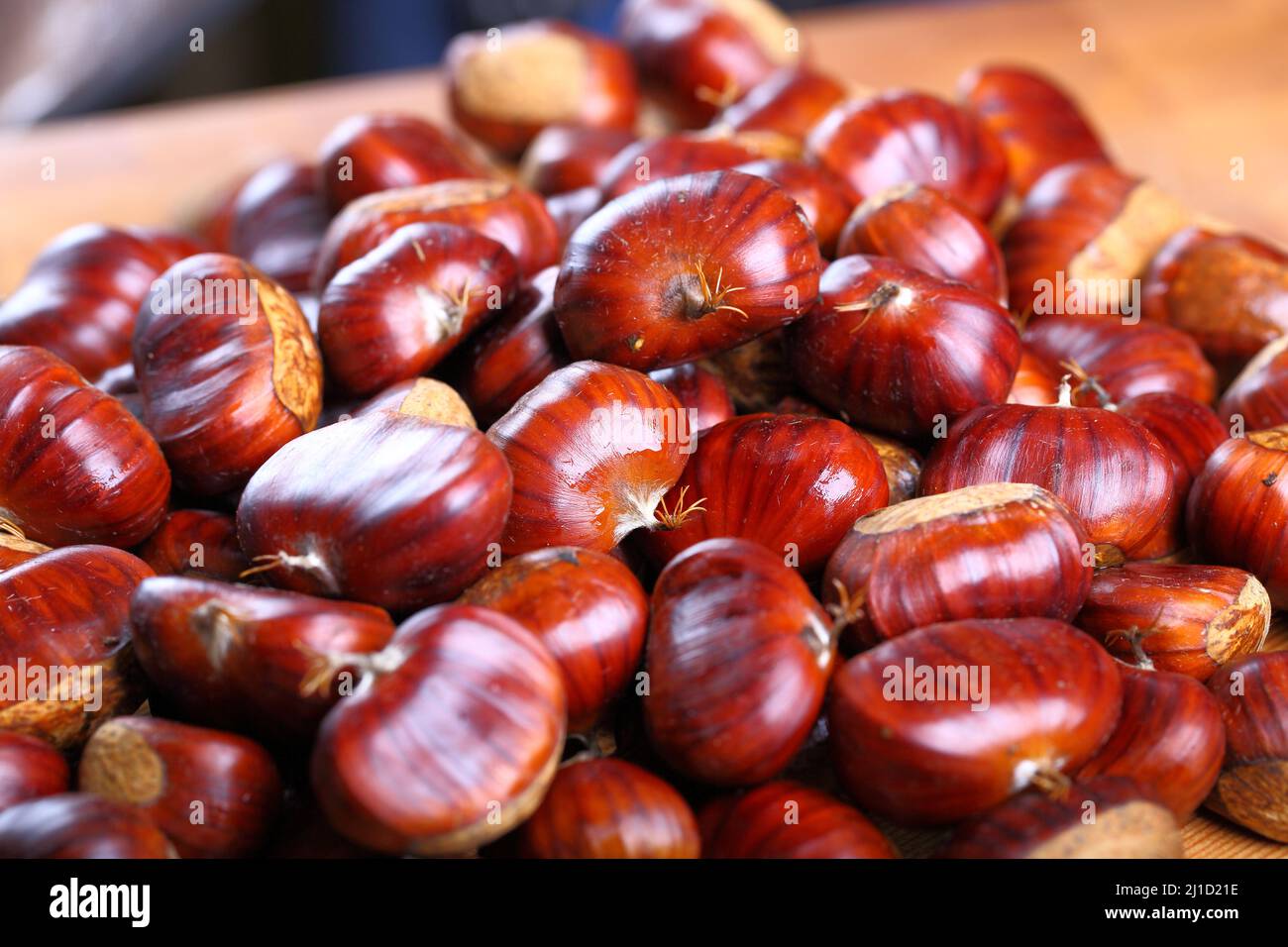 Chestnusts on wooden background Stock Photo - Alamy