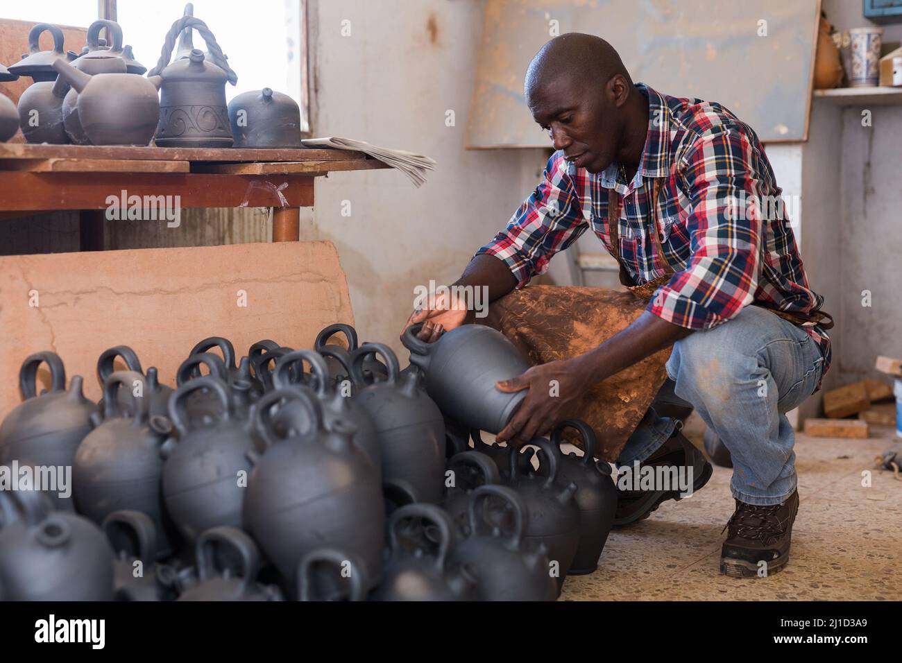 Potter checking quality of ceramic objects Stock Photo - Alamy