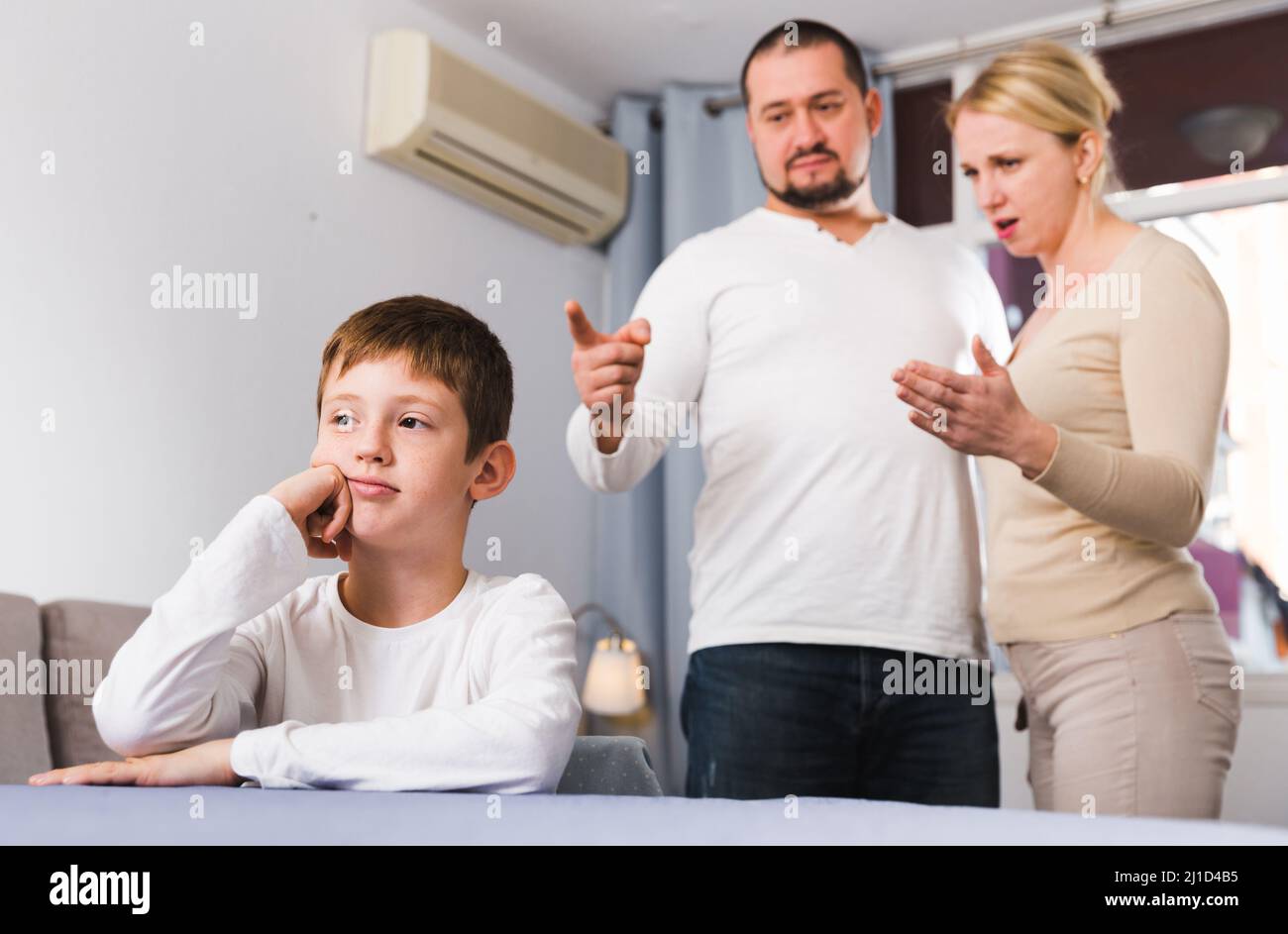 Parents berating frustrated boy Stock Photo - Alamy