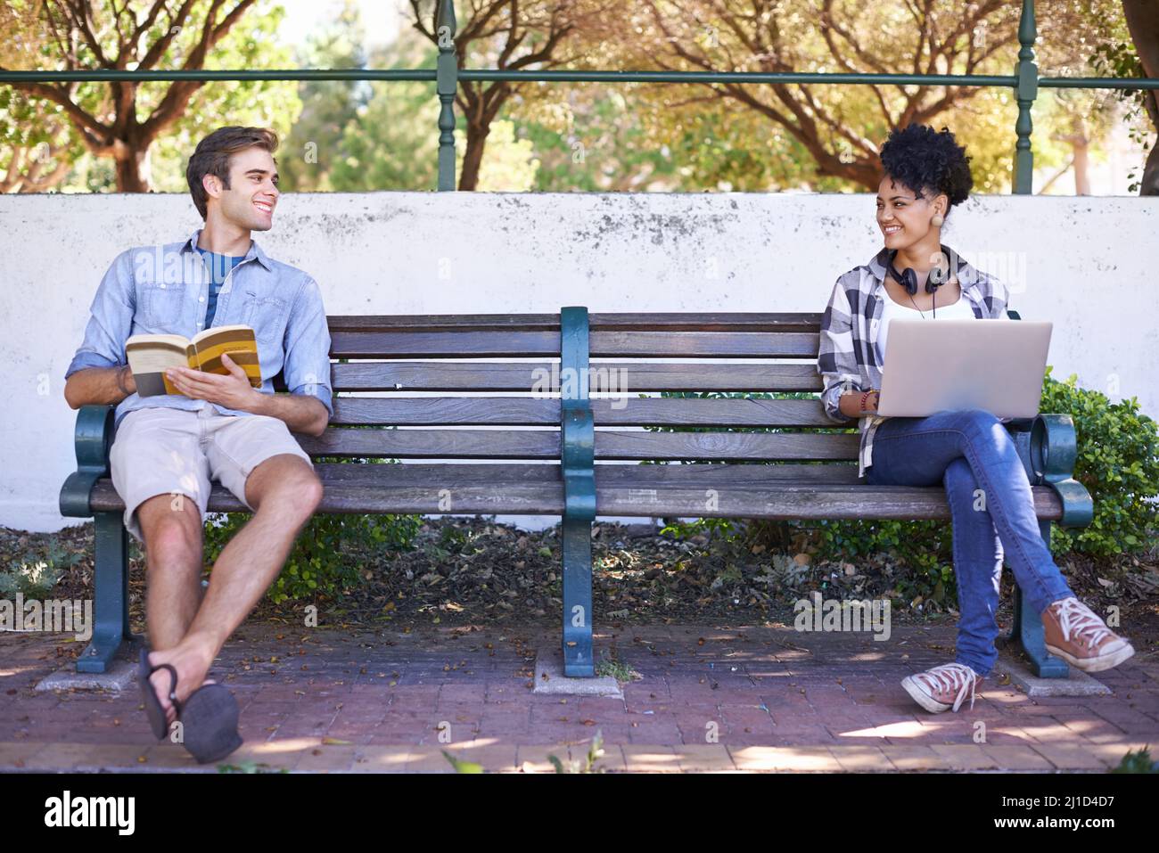 Noticing each other for the first time. Two students sitting on ...