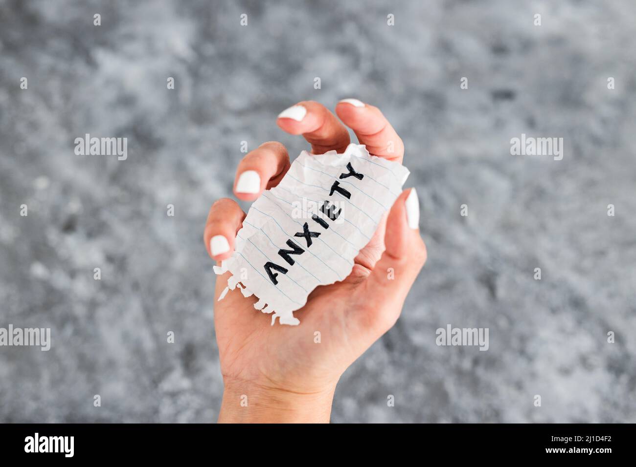 hand holding Anxiety text on scrunched up piece of paper, psychology or ...