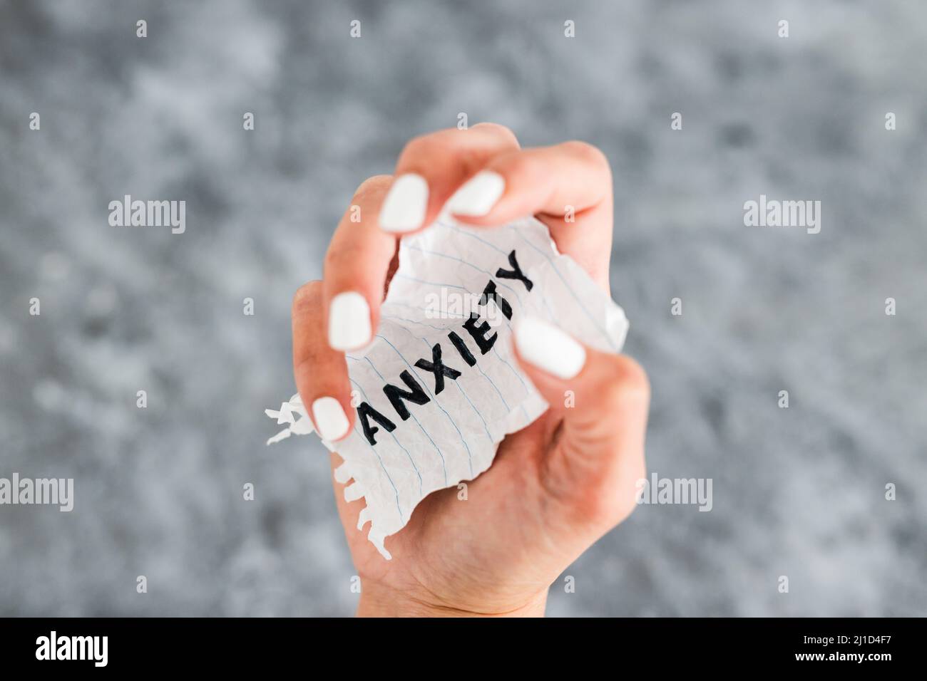 hand holding Anxiety text on scrunched up piece of paper, psychology or ...