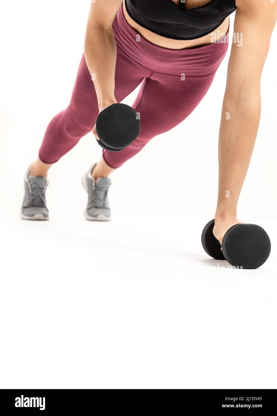 Woman lifting dumbells Stock Photo - Alamy