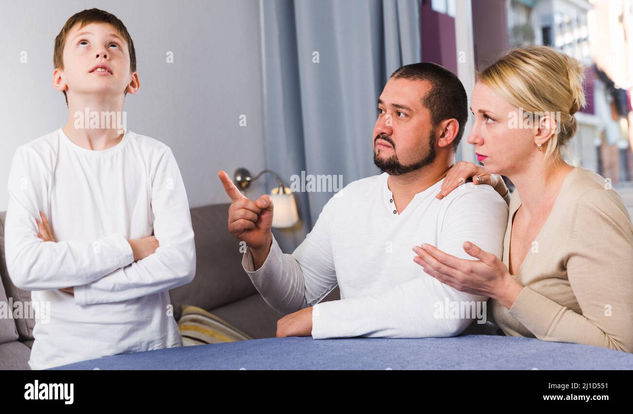 Serious parents scolding son Stock Photo - Alamy