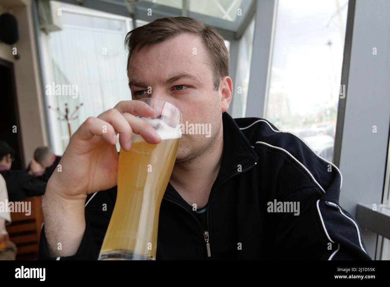 The man drinking a draught beer in restaurant Stock Photo - Alamy