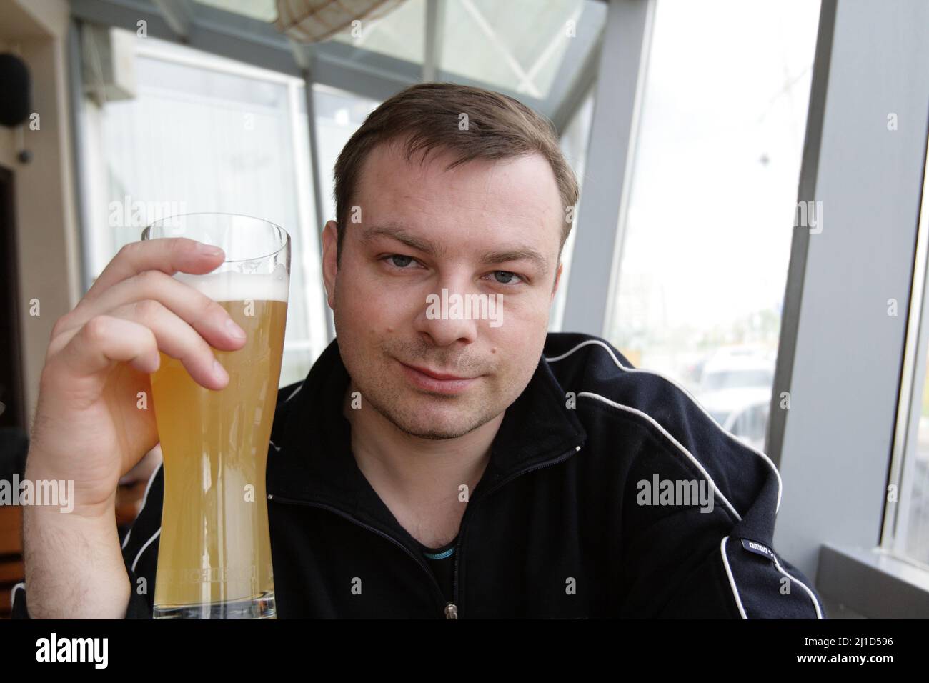 The man poses in a restaurant with beer Stock Photo - Alamy