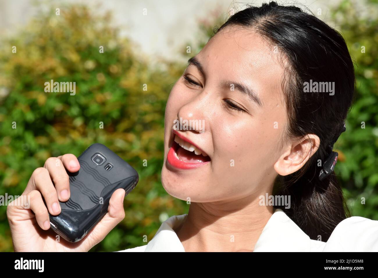 Singing into phone hi-res stock photography and images - Alamy