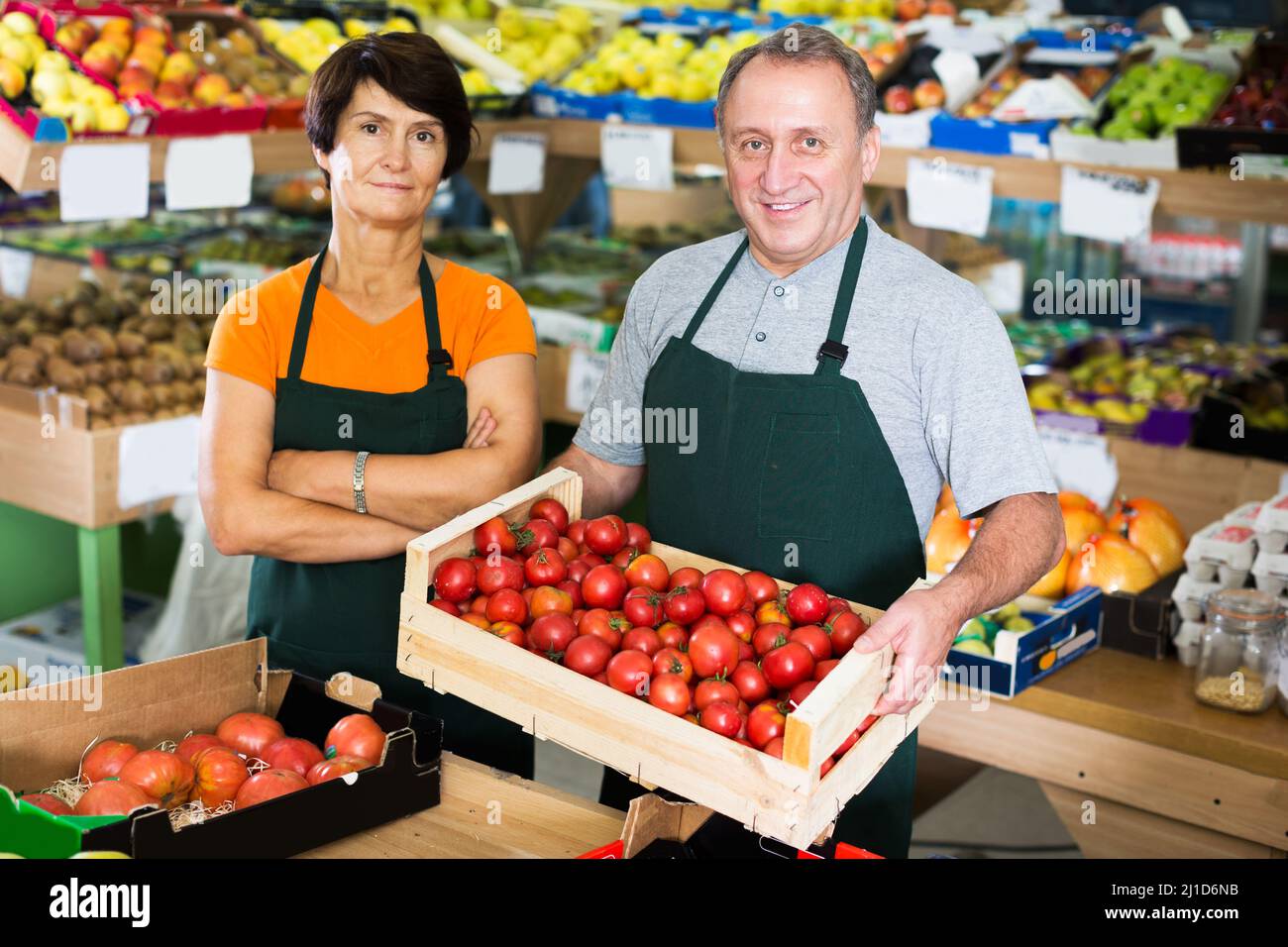 Two sellers are offering red tomatos Stock Photo - Alamy