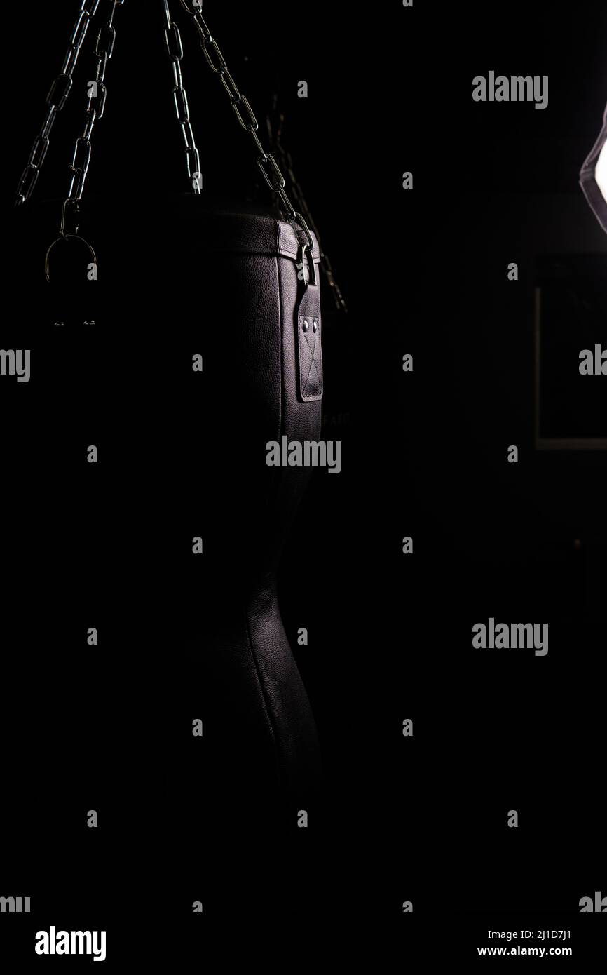On black background, crop copy spase bag black punching boxing ...