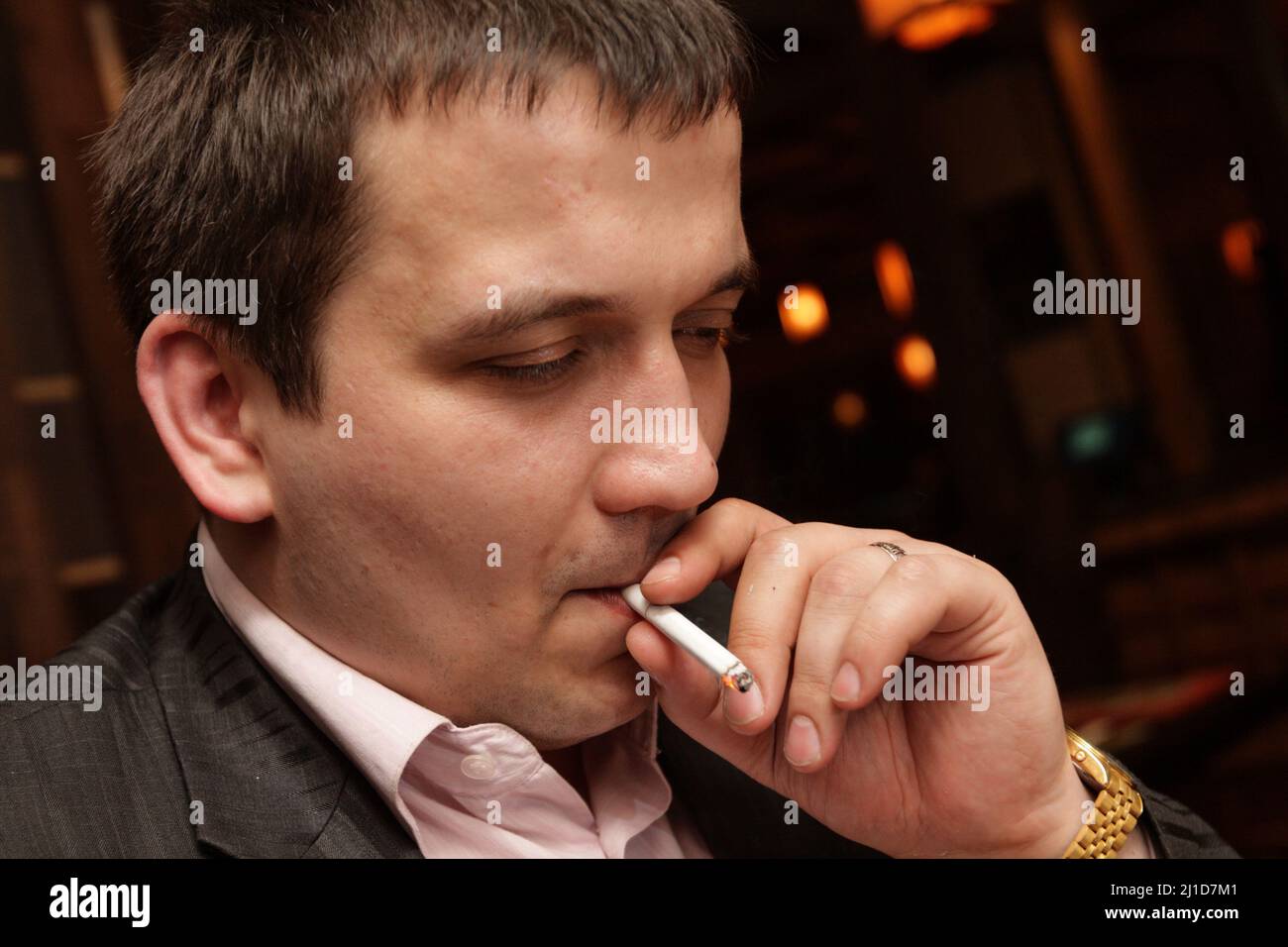 The mid adult man smoking in a cafe Stock Photo - Alamy
