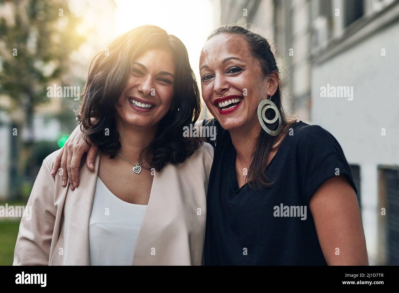 Best friends in the city. Cropped shot of two friends posing together while out in the city ...