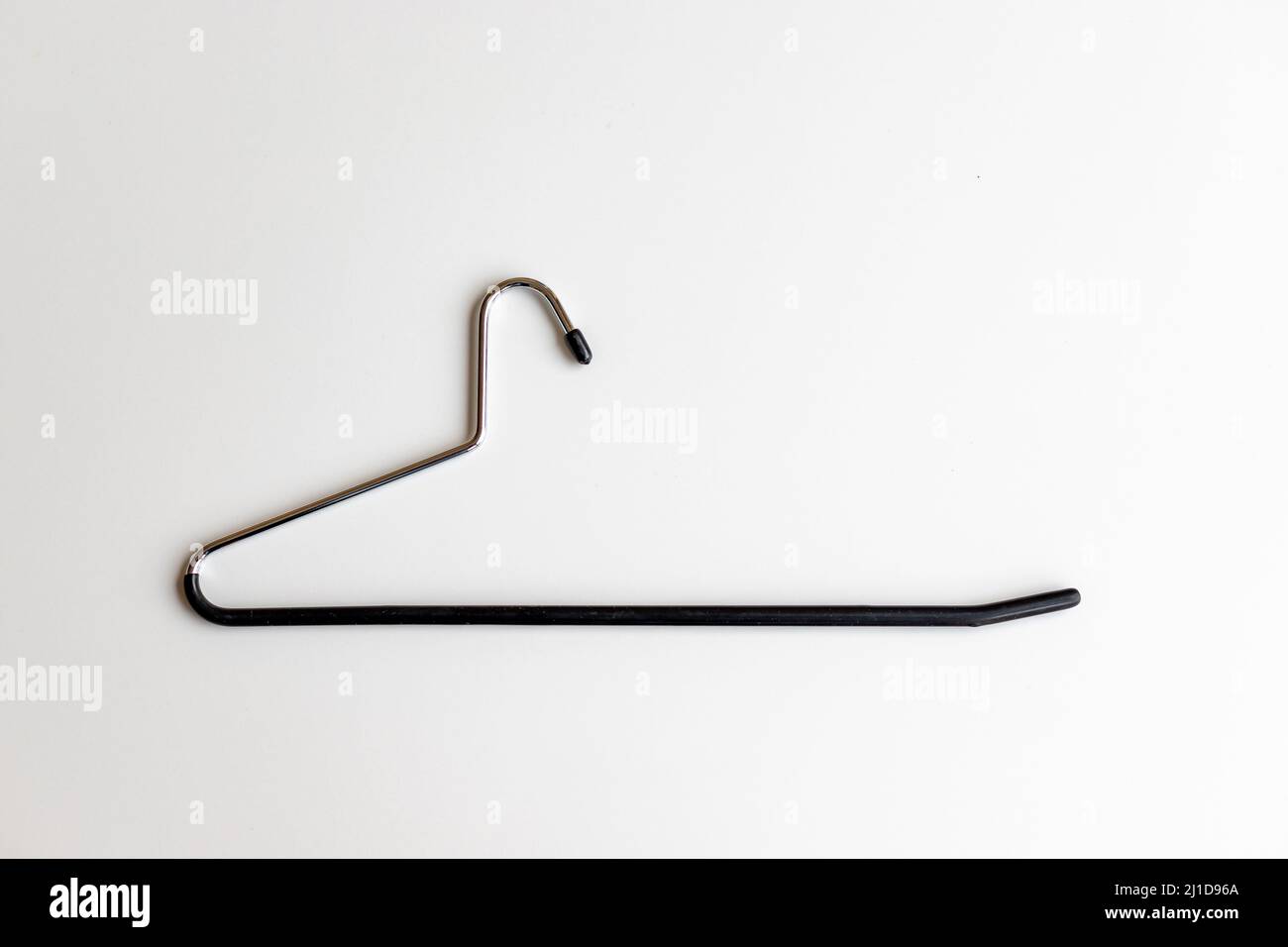 L shape hanger for pants, trousers and jeans on a white background ...