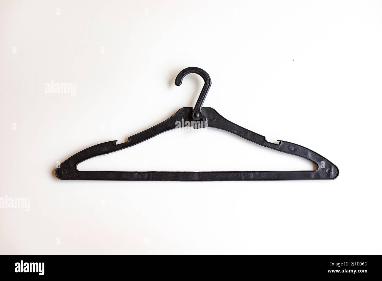 Black plastic hanger on white isolated background Stock Photo - Alamy