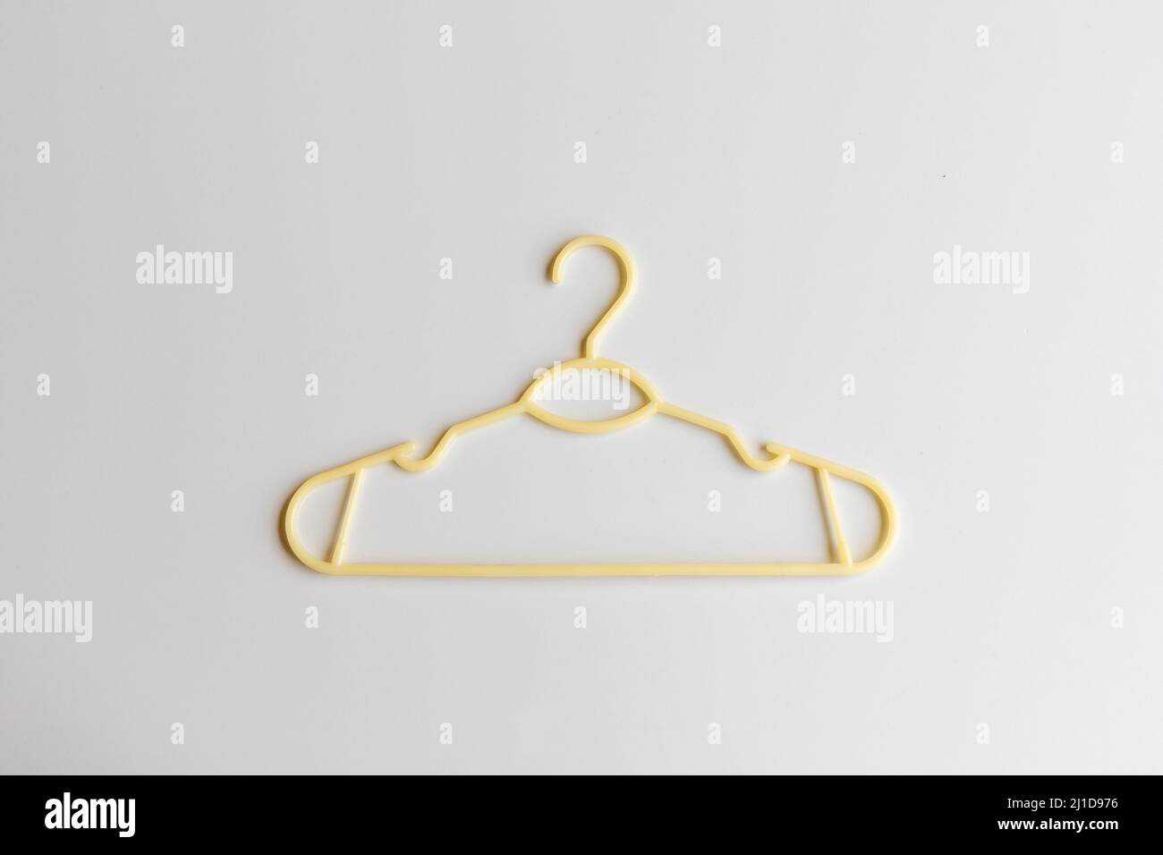 Baby cloth hanger yellow color small hanger on white background Stock ...