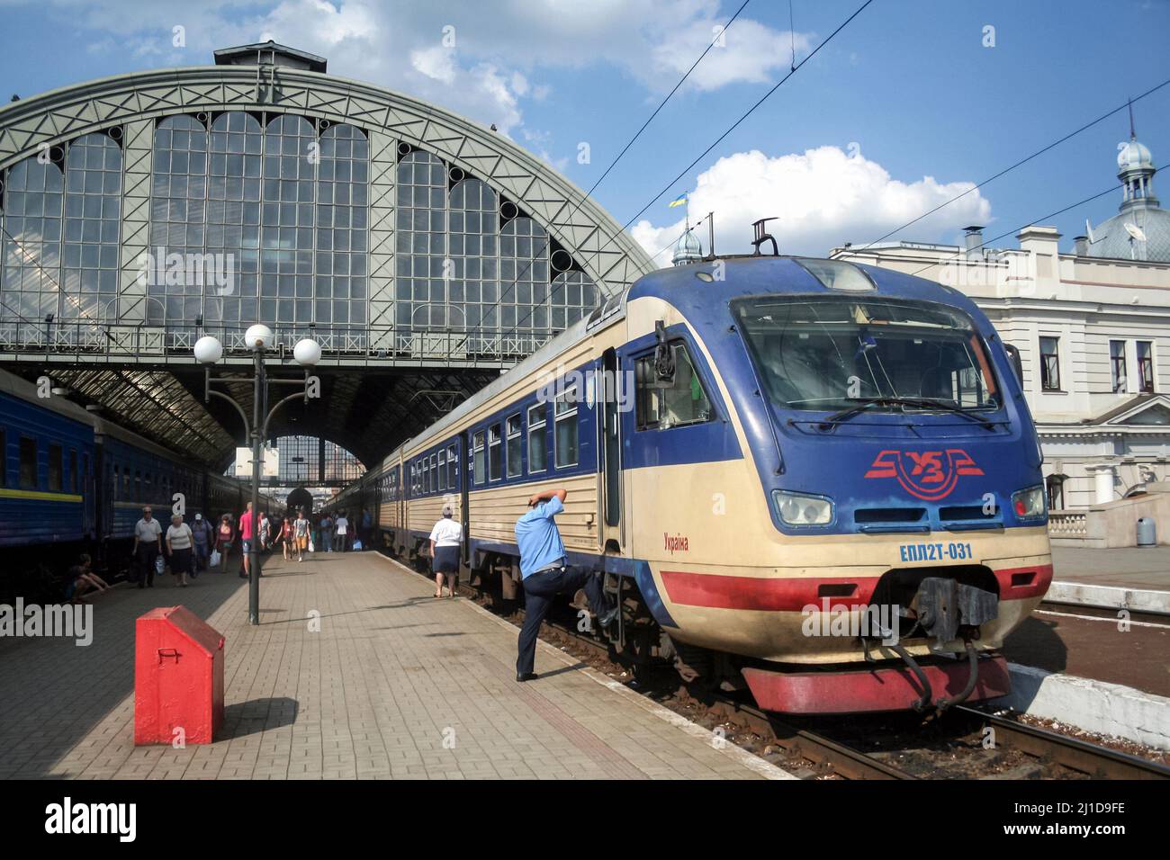 Picture of Ukrainian railworker boarding a passenger train of Ukrainian ...