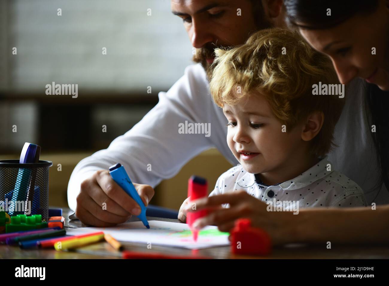 Happy family having fun draw together at a home, parents and little ...