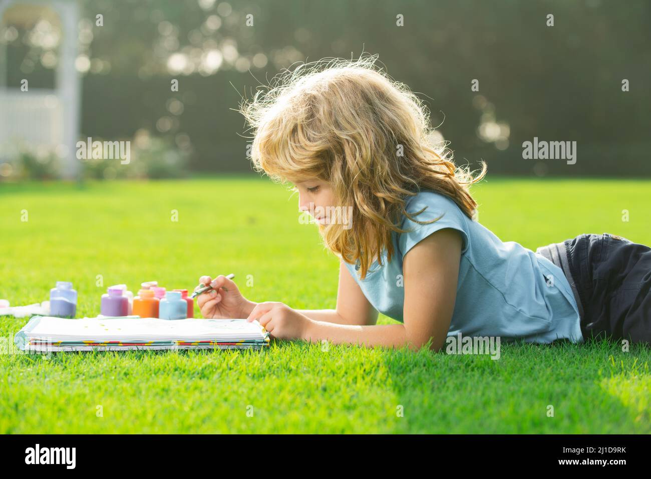 Kids drawing. Child boy drawing in summer park, painting art. Little ...