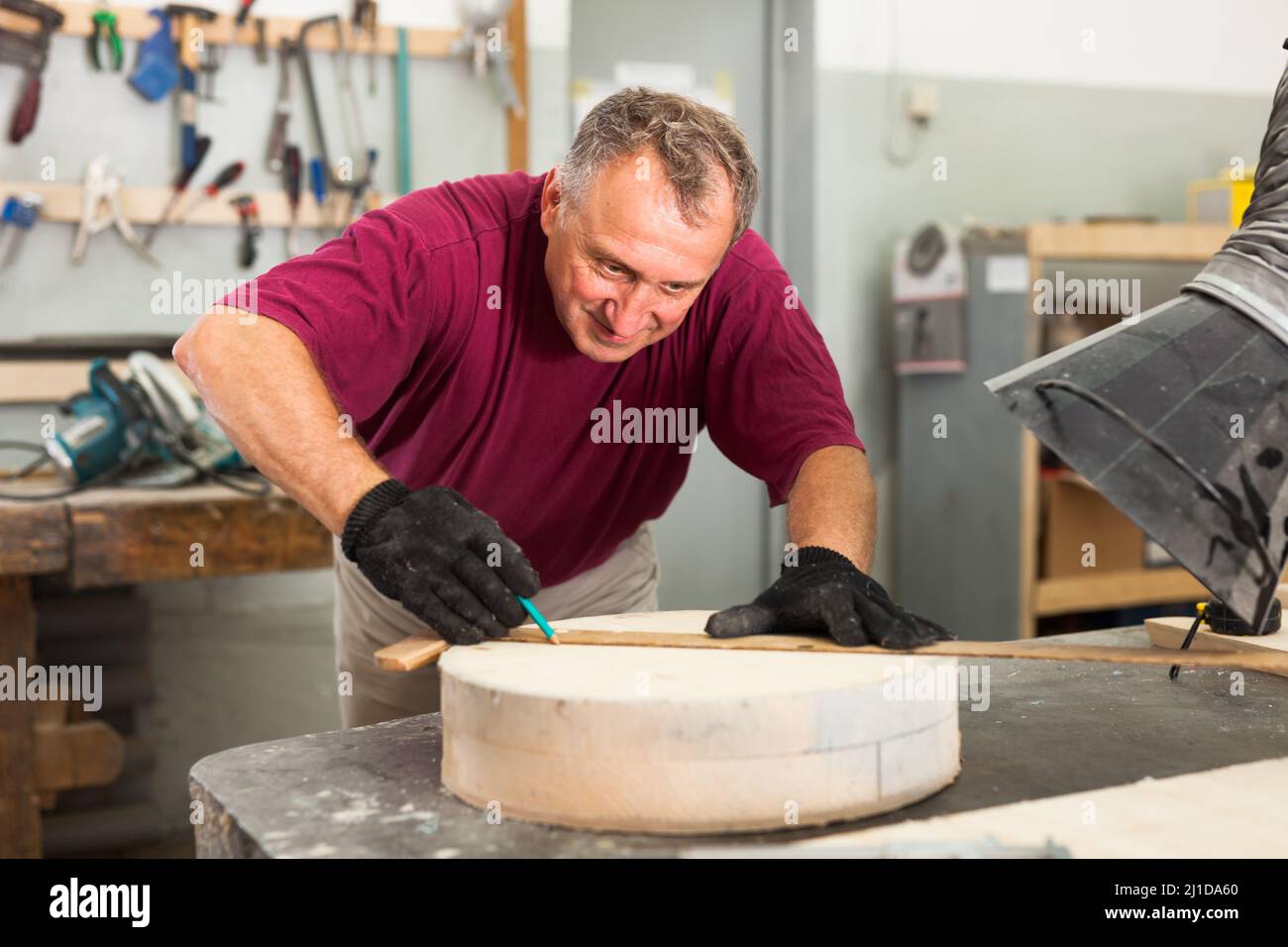 Worker performs measurements on wooden workpiece with caliper. Working ...