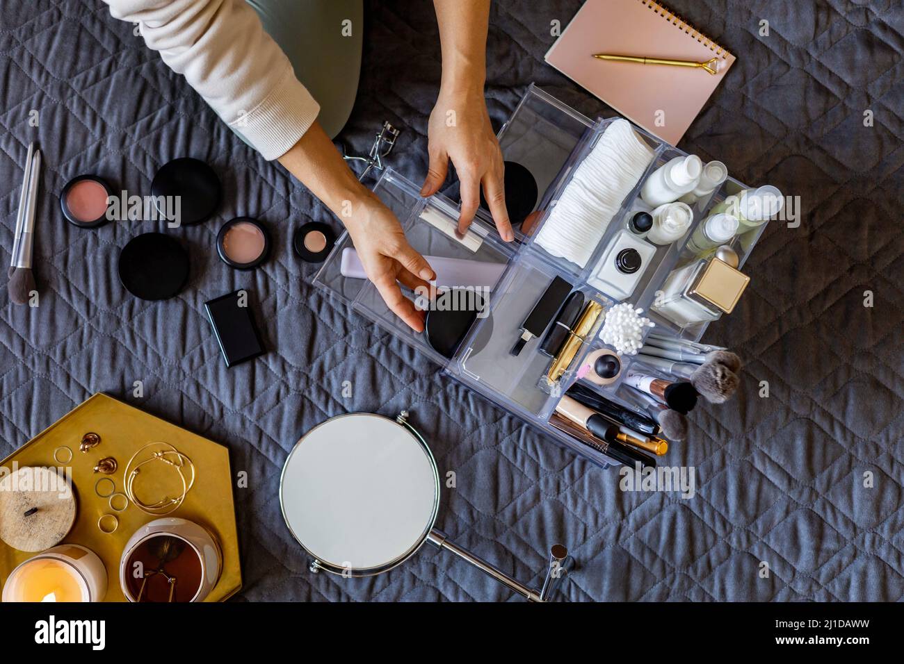 Woman hands tidying up putting powder container into acrylic storage ...
