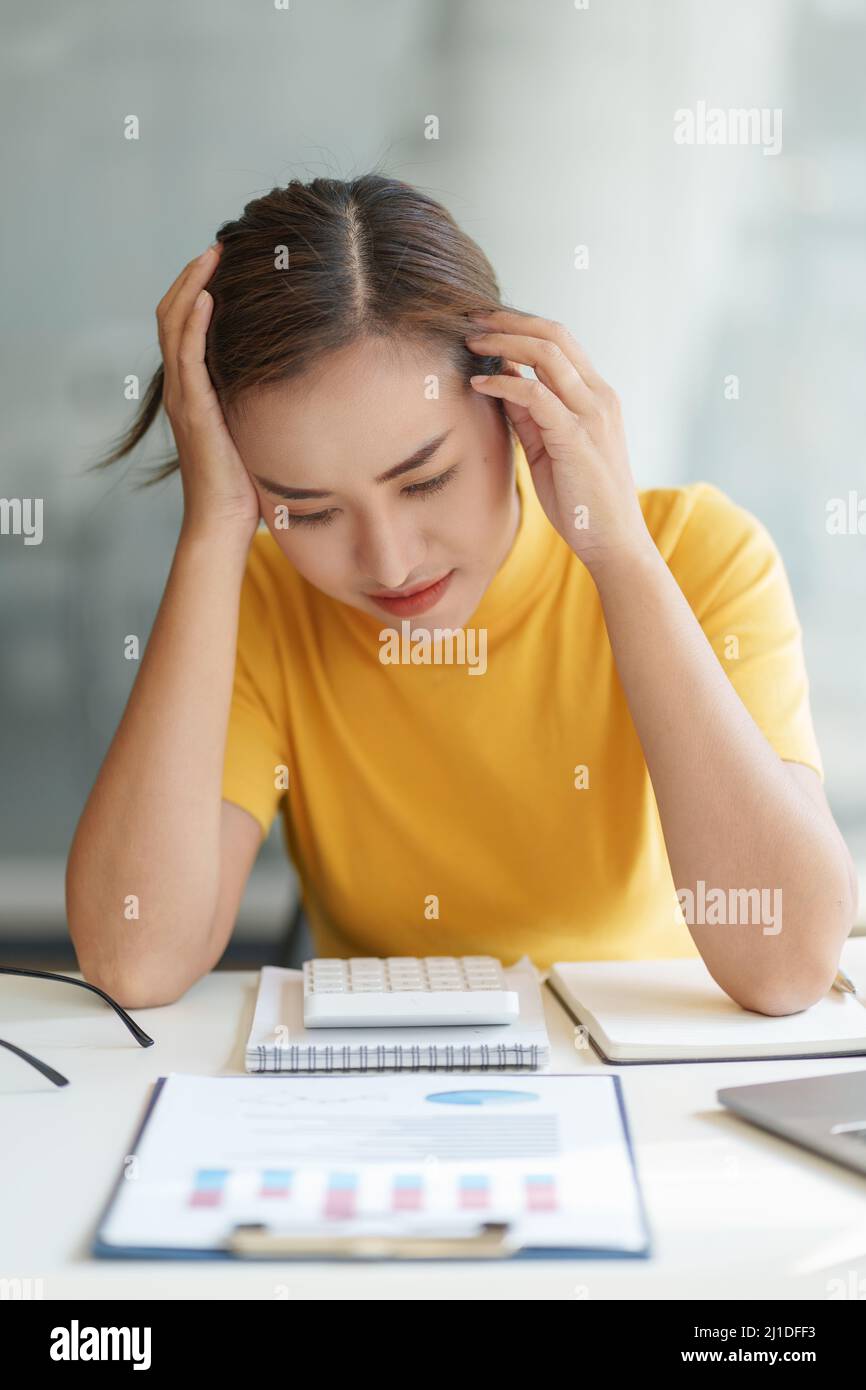 Asian business woman worry about marketing plan of this years. Finance ...