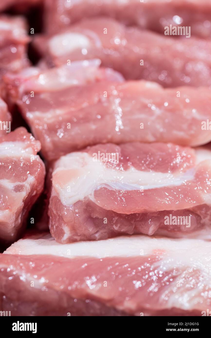 Close up top view pack pieces raw meat of pork loin on bone, fresh red ...