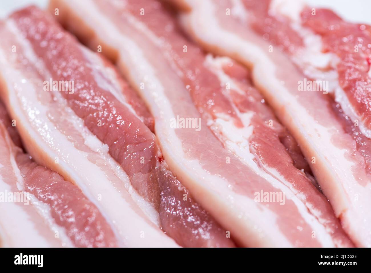 Closeup top view pieces fresh raw meat of pork belly with white fat and ...